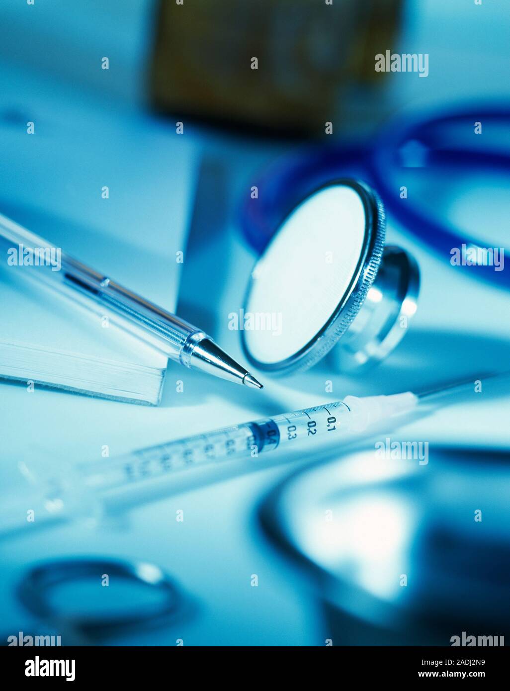 General practitioner's equipment on a desk. A stethoscope (far right ...