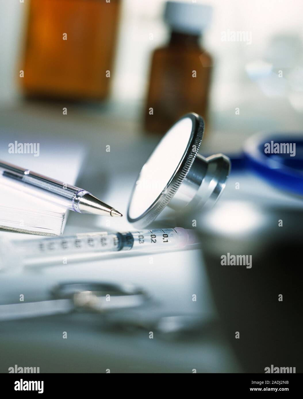 General practitioner's equipment on a desk. A stethoscope (centre ...