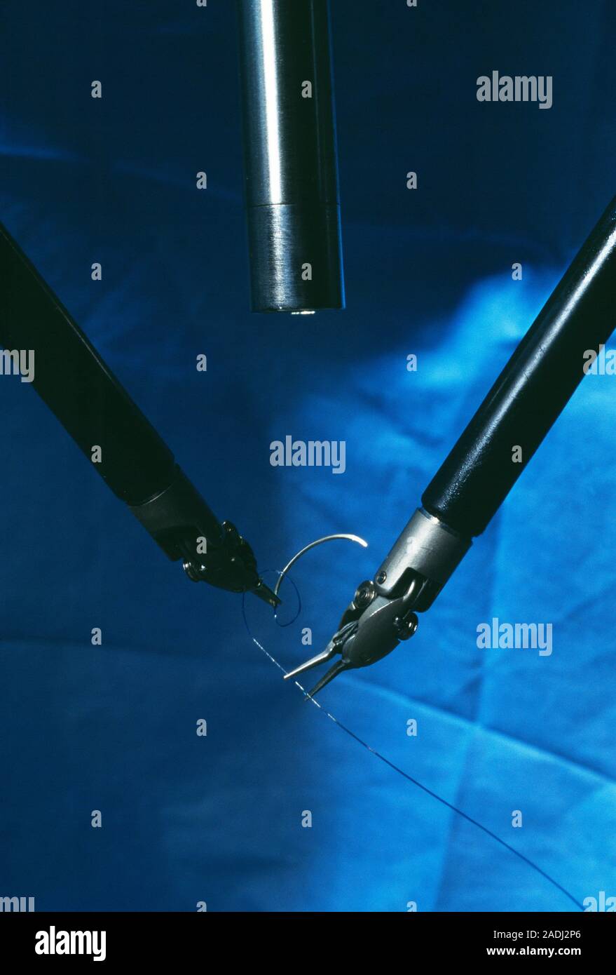 Surgical robot. Manipulators of the Da Vinci surgical robot system holding suture line used for ...