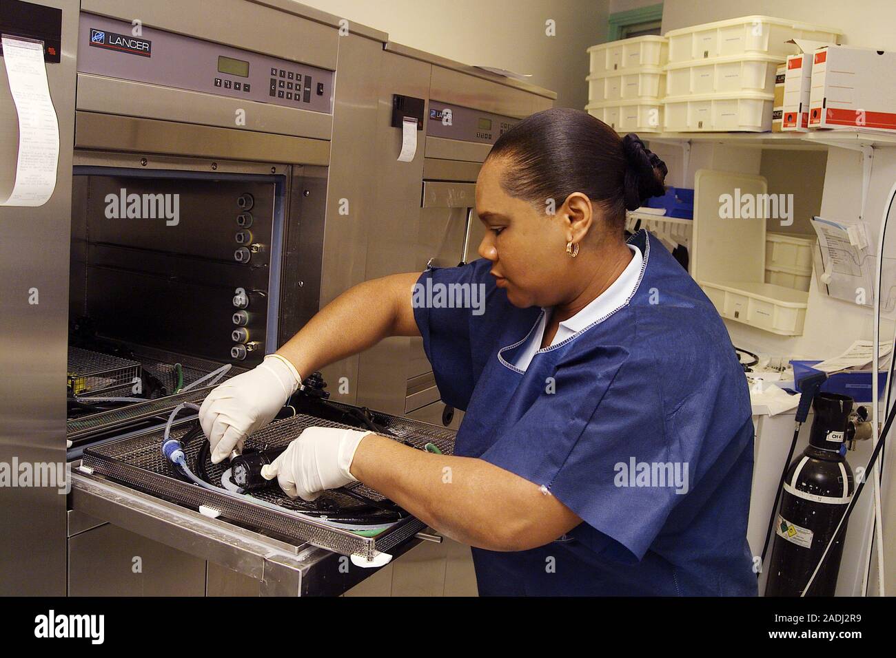 Autoclave oven. Hospital worker putting an endoscope into an autoclave ...