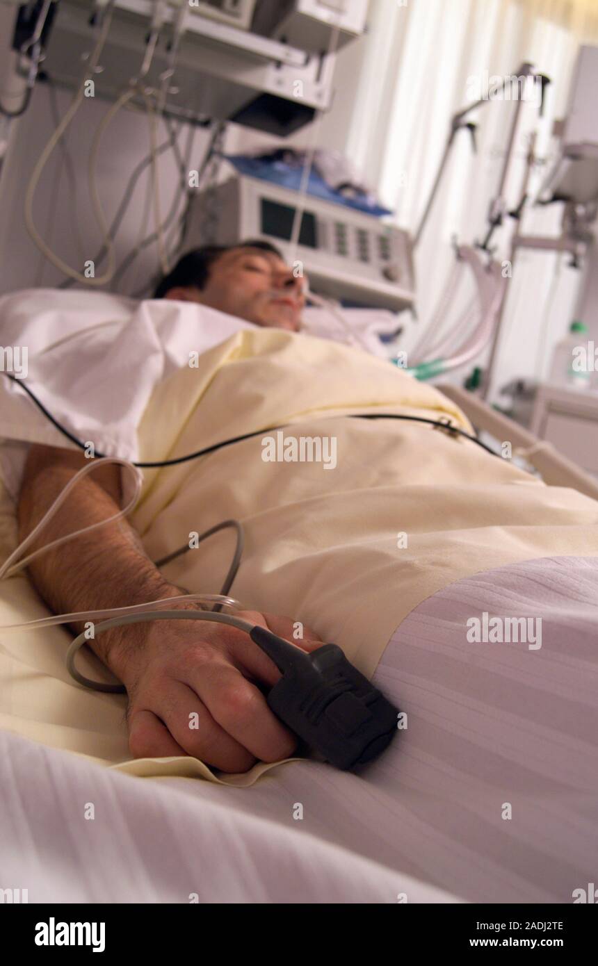 Oxygen meter on the finger of a patient in a hospital's intensive care ...