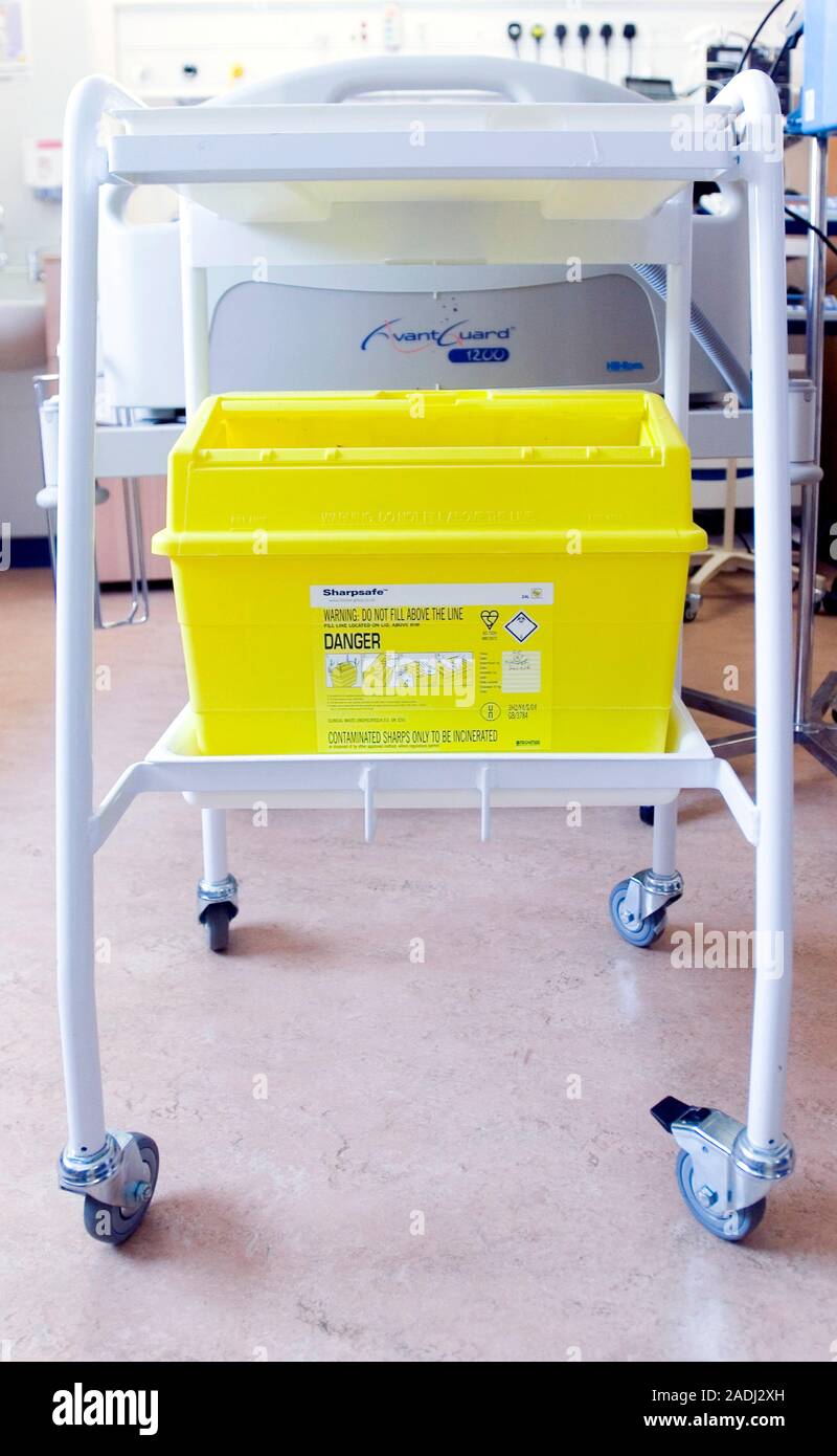 Sharps bin for the disposal of used needles in a hospital Stock Photo ...