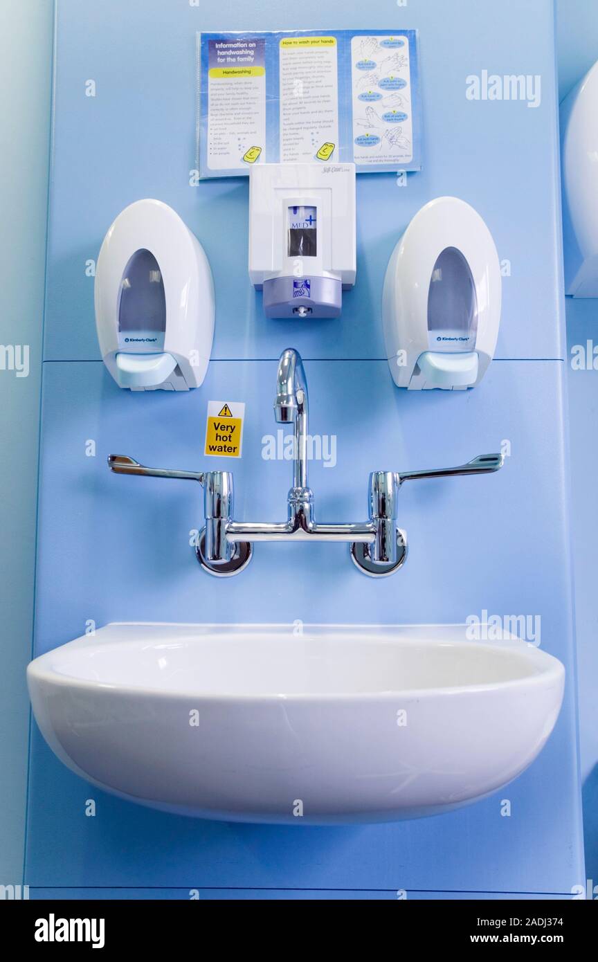 Hospital sink. Soap and disinfectant dispensers over a hospital sink ...