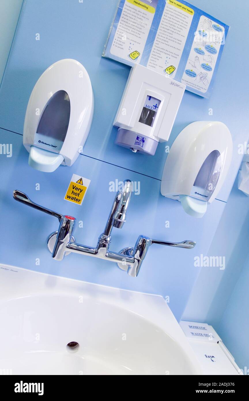 Hospital sink. Soap and disinfectant dispensers over a hospital sink ...