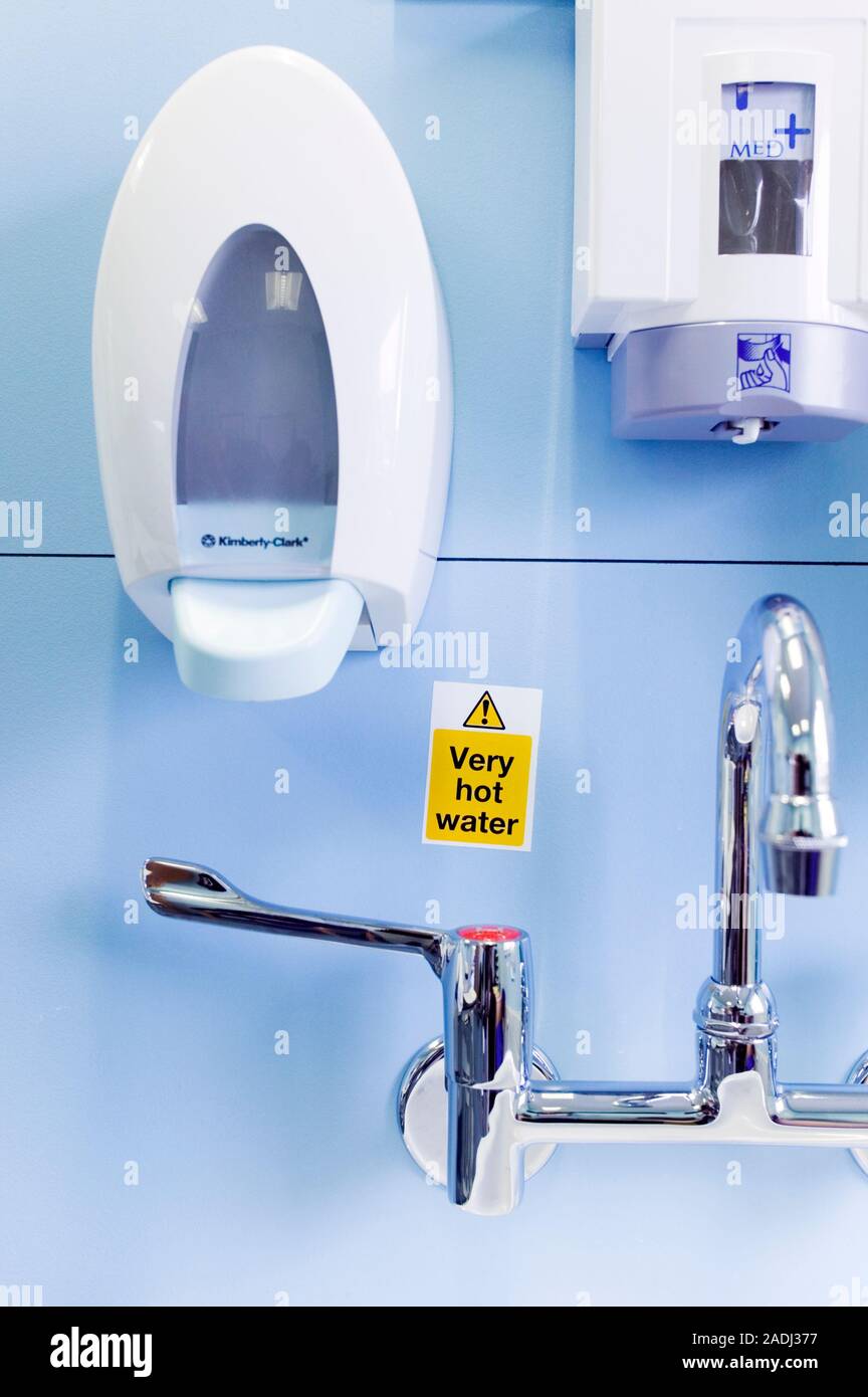 Hospital sink. Soap and disinfectant dispensers over a hospital sink ...