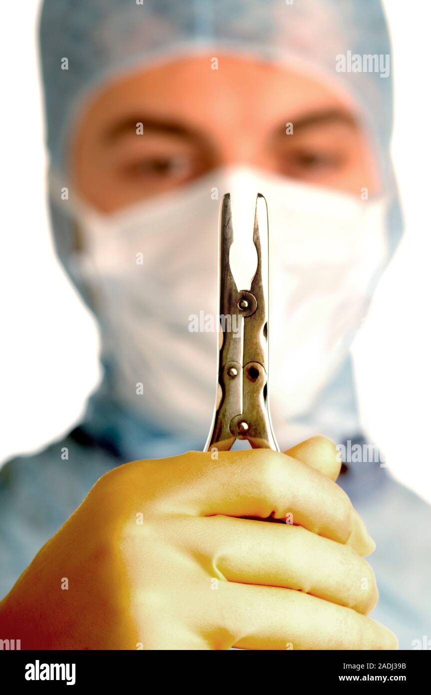 MODEL RELEASED. Bone Nibbler instrument held by an orthopedic surgeon ...