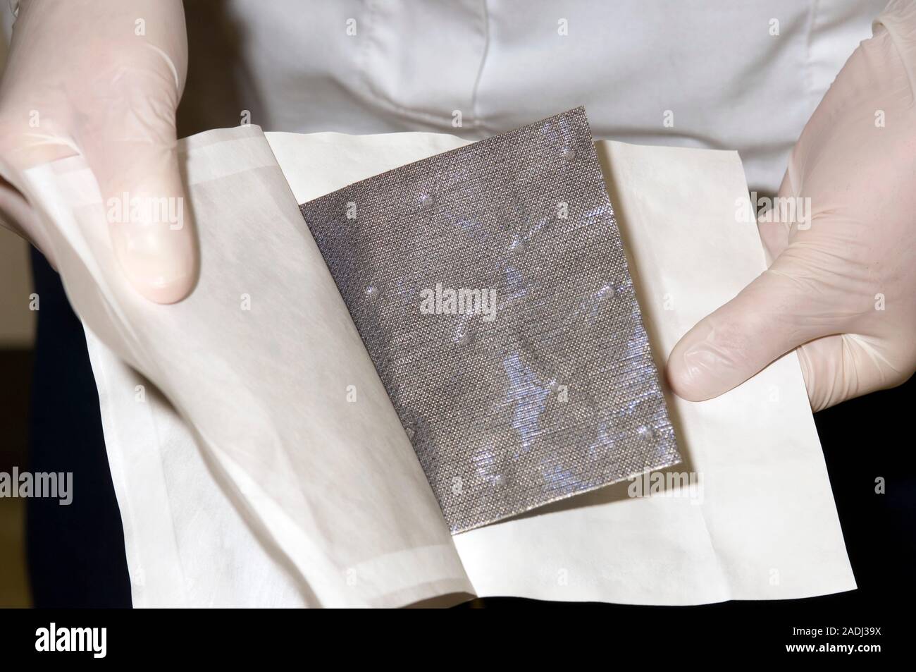 Acticoat 7 wound dressing. Healthcare worker peeling back the packaging ...