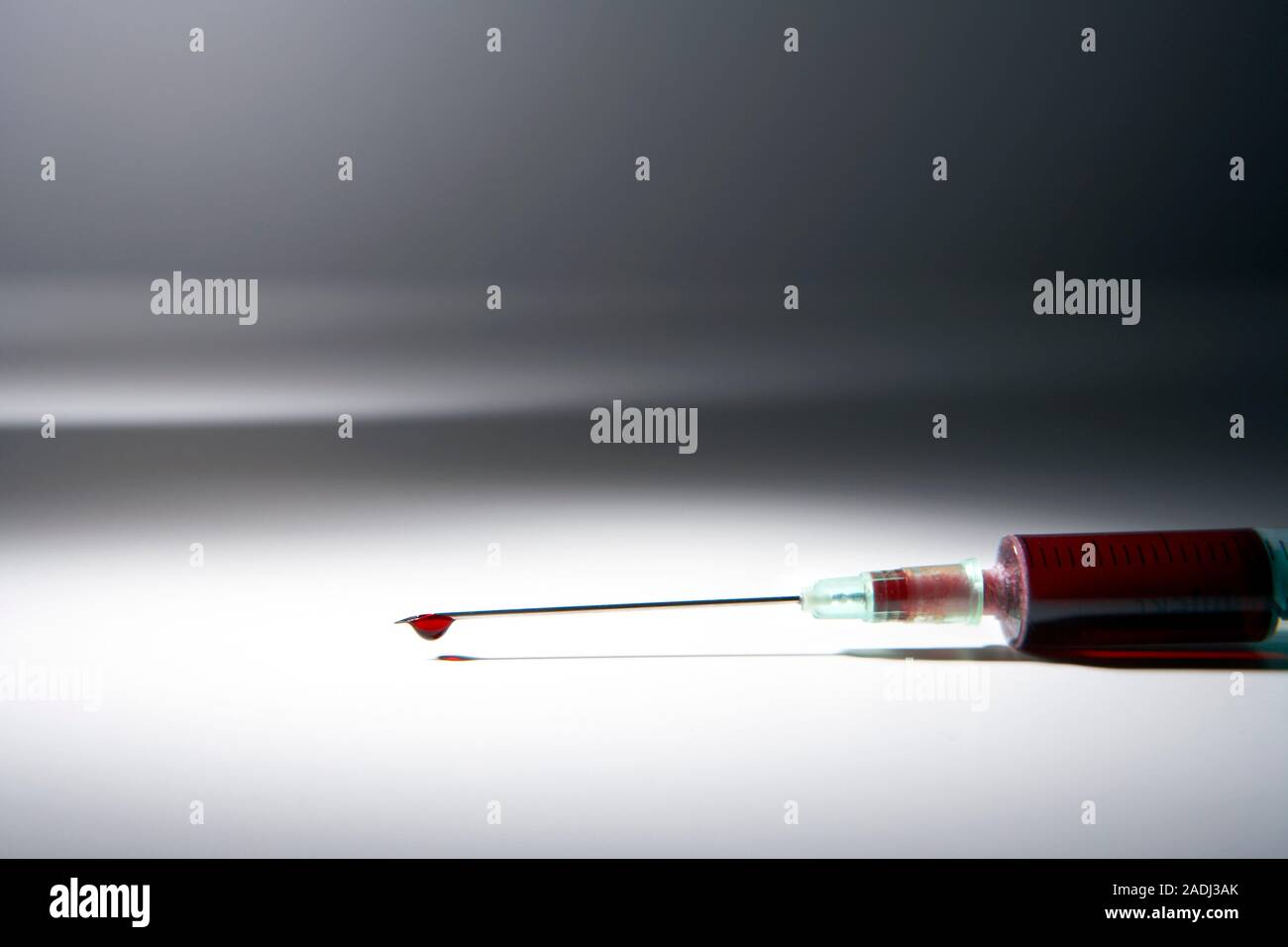 Hypodermic needle with a drop of blood on the needle Stock Photo - Alamy