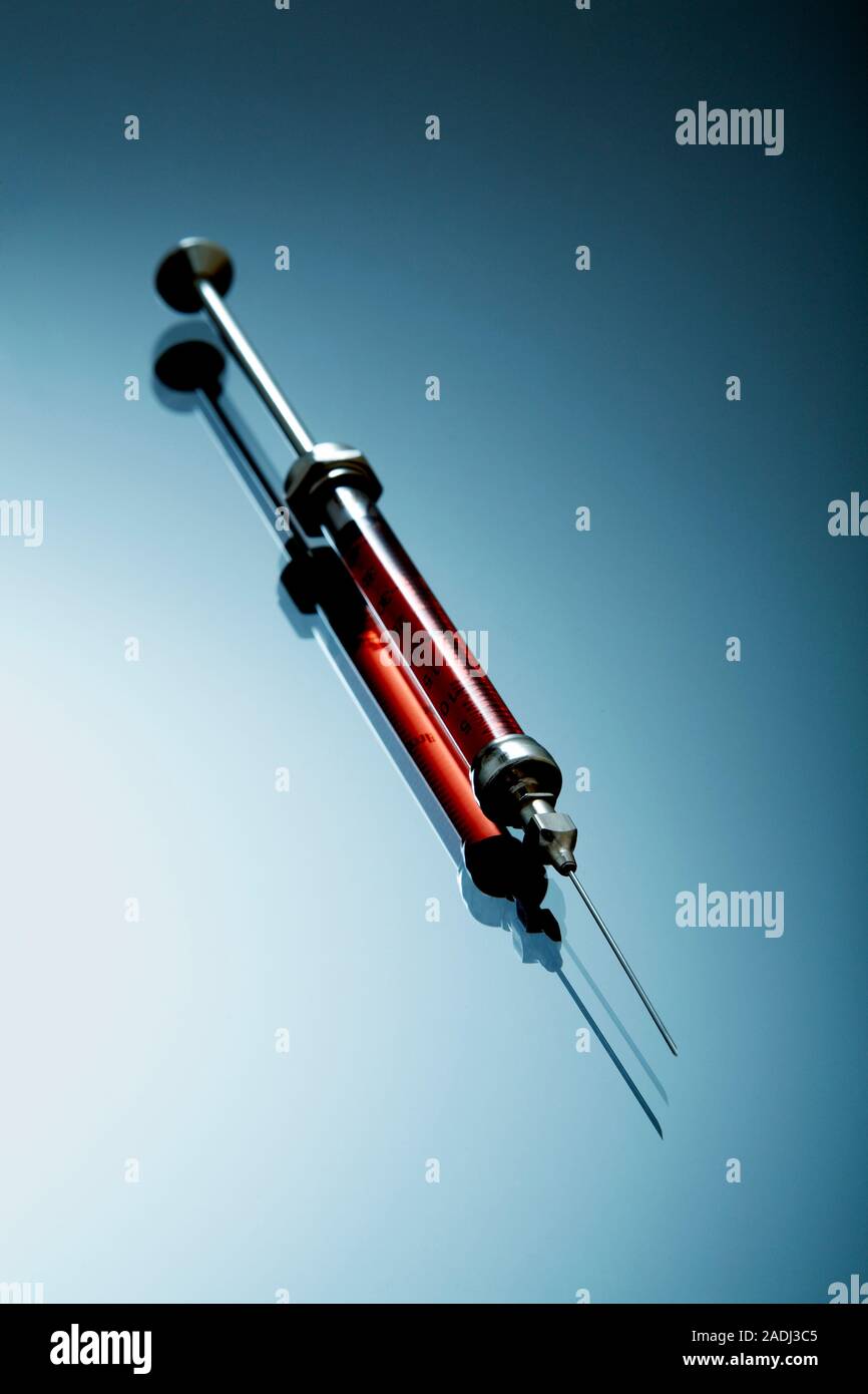 Blood-filled syringe. Old fashioned syringe filled with blood Stock ...