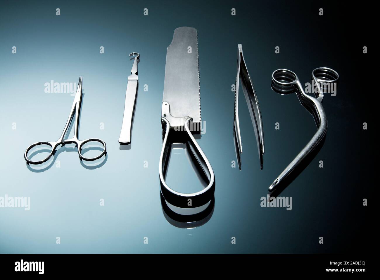 Surgical instruments. From left: artery forceps, spay hook, bone saw ...