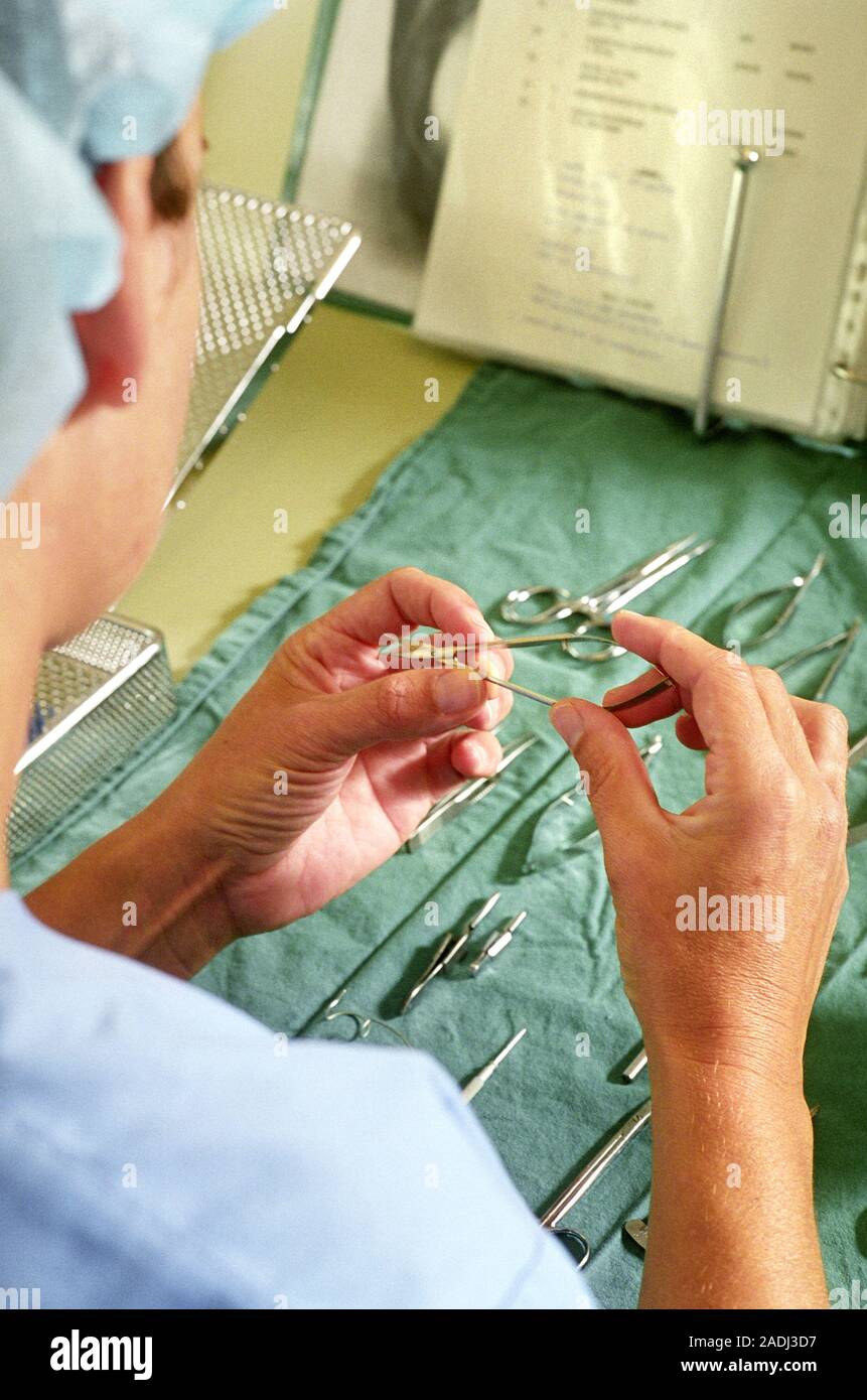 Surgical instruments. Medical technician sorting out instruments that ...