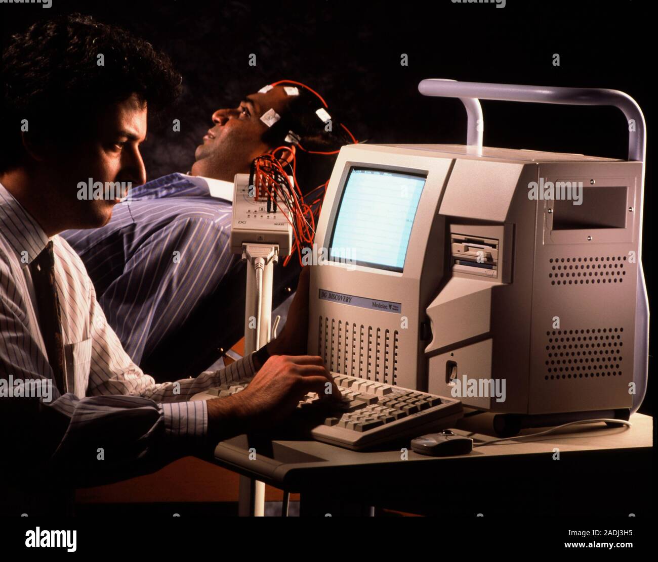 Electroencephalography. Doctor monitoring a patient's brain activity ...