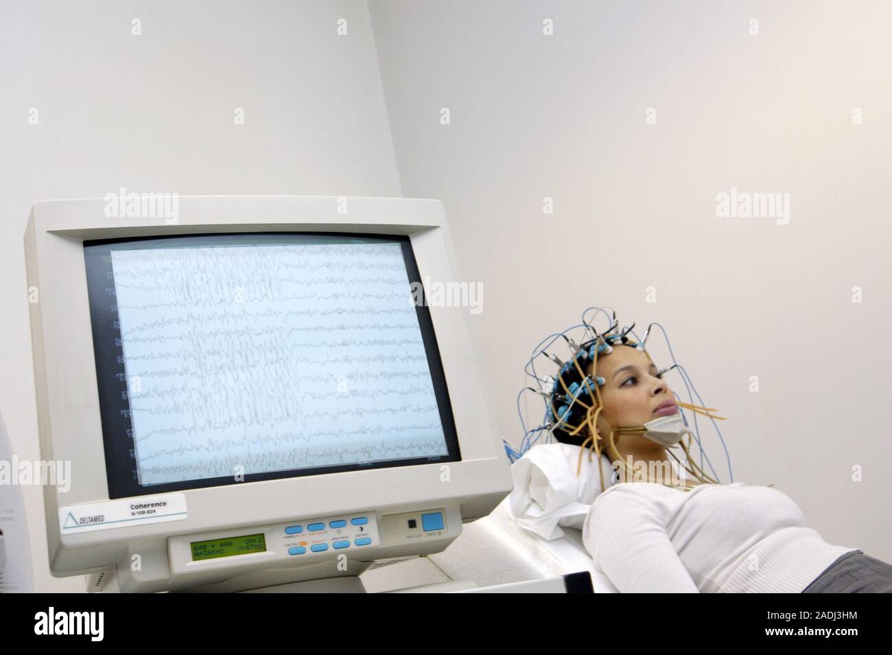 EEG examination. 27-year-old woman undergoing an electroencephalograph ...