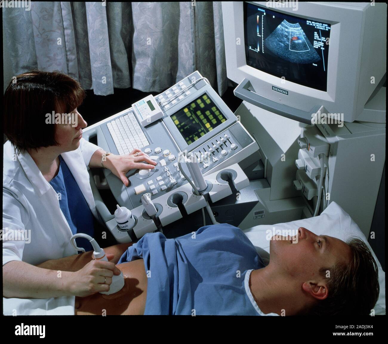 Ultrasound scanning. Doctor uses a doppler ultrasound scanner to ...