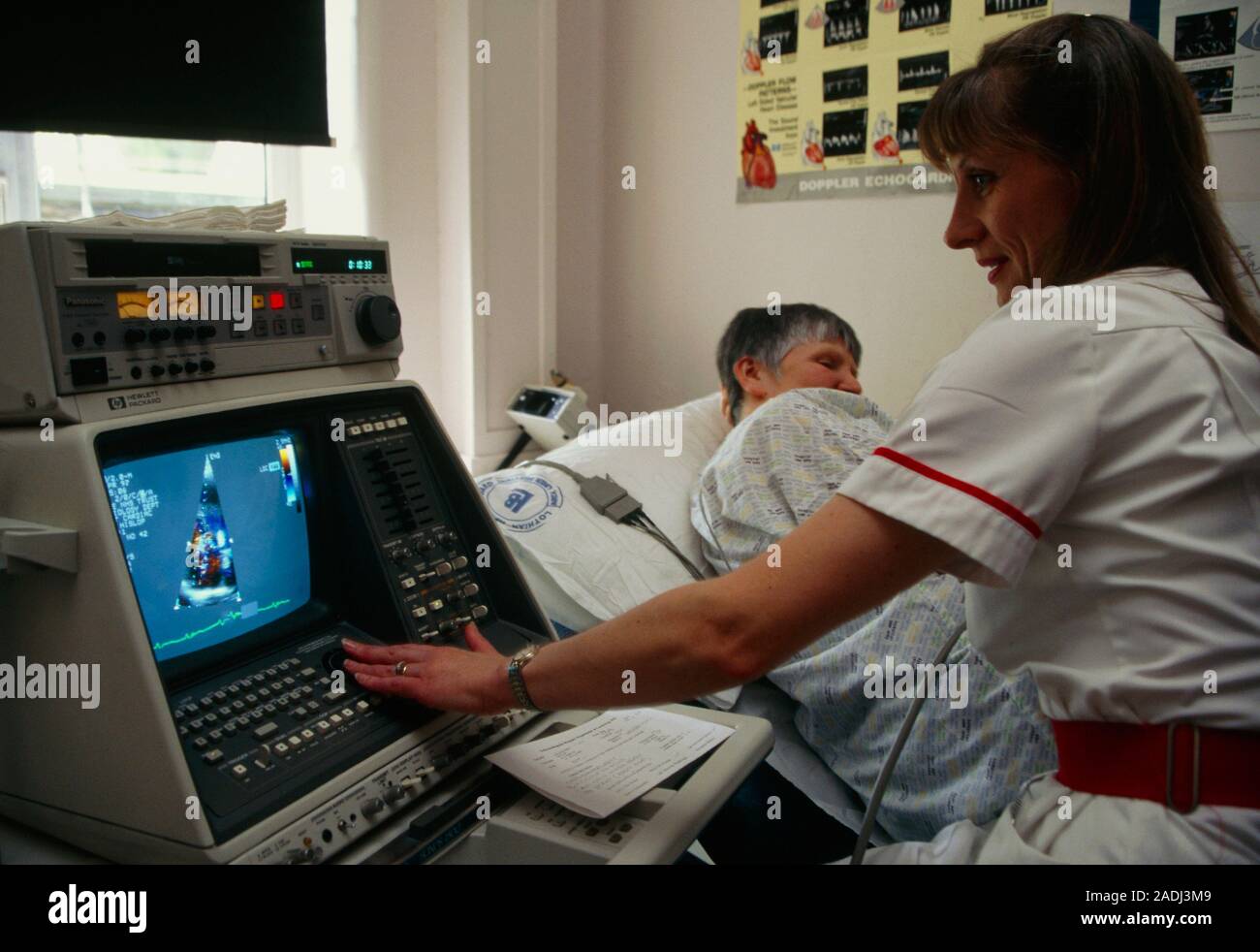Heart ultrasound scan. Nurse using an ultrasound scanning machine to ...