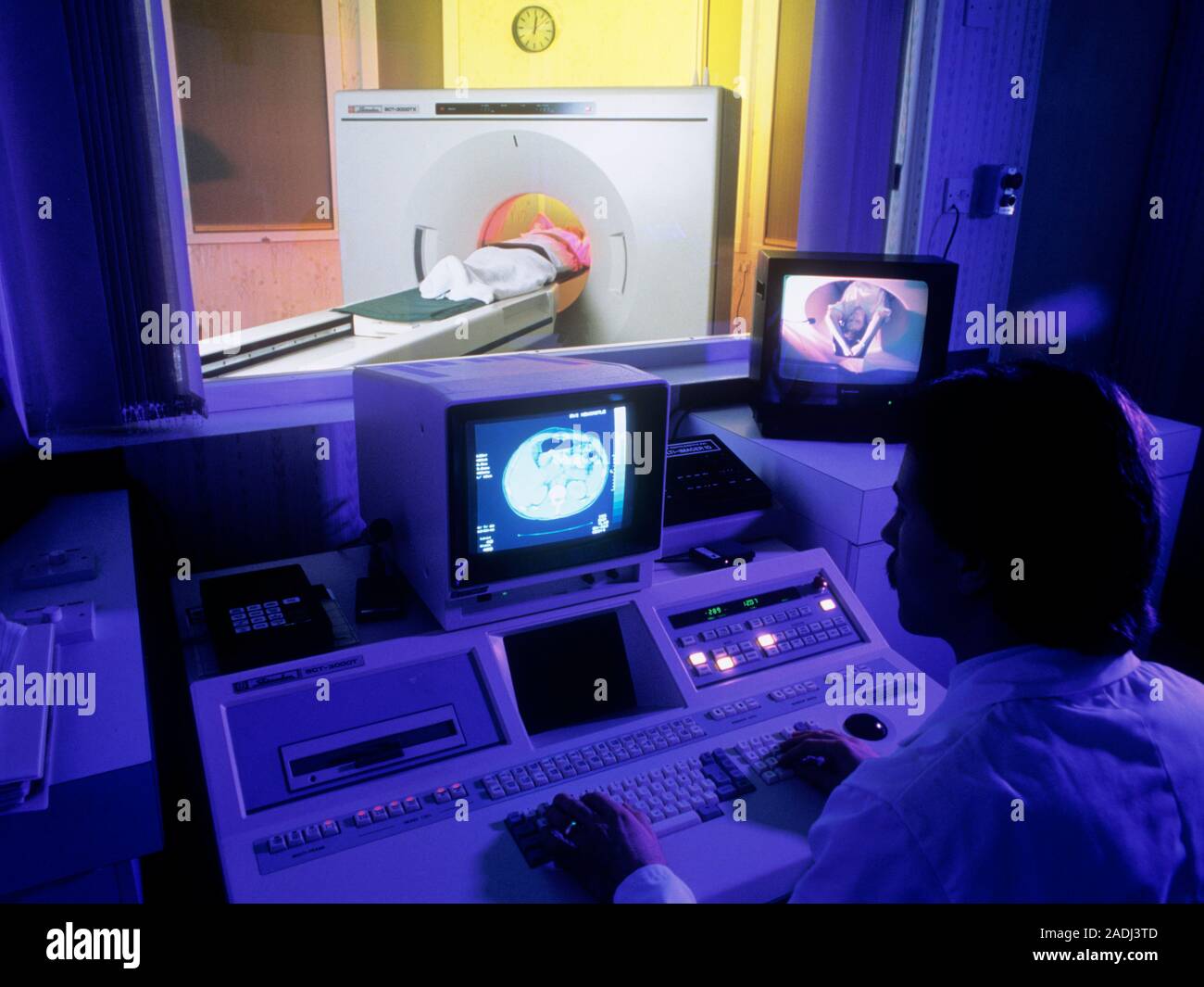 Computed tomography (CT) scan in progress, showing the scanner and ...