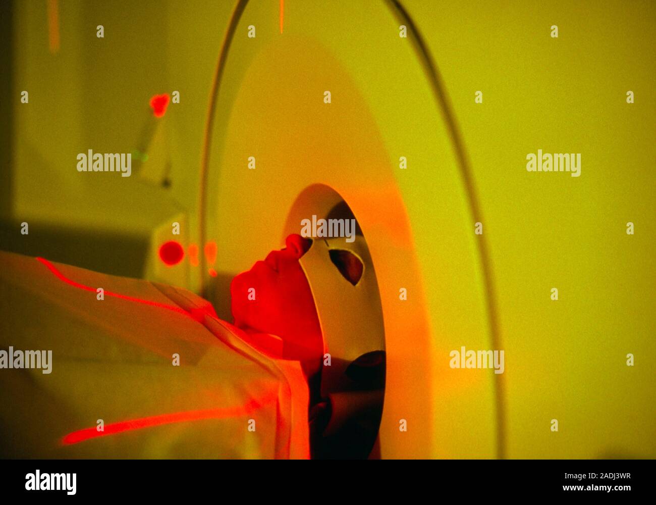 PET scanning. Side view of a patient undergoing a Positron Emission ...