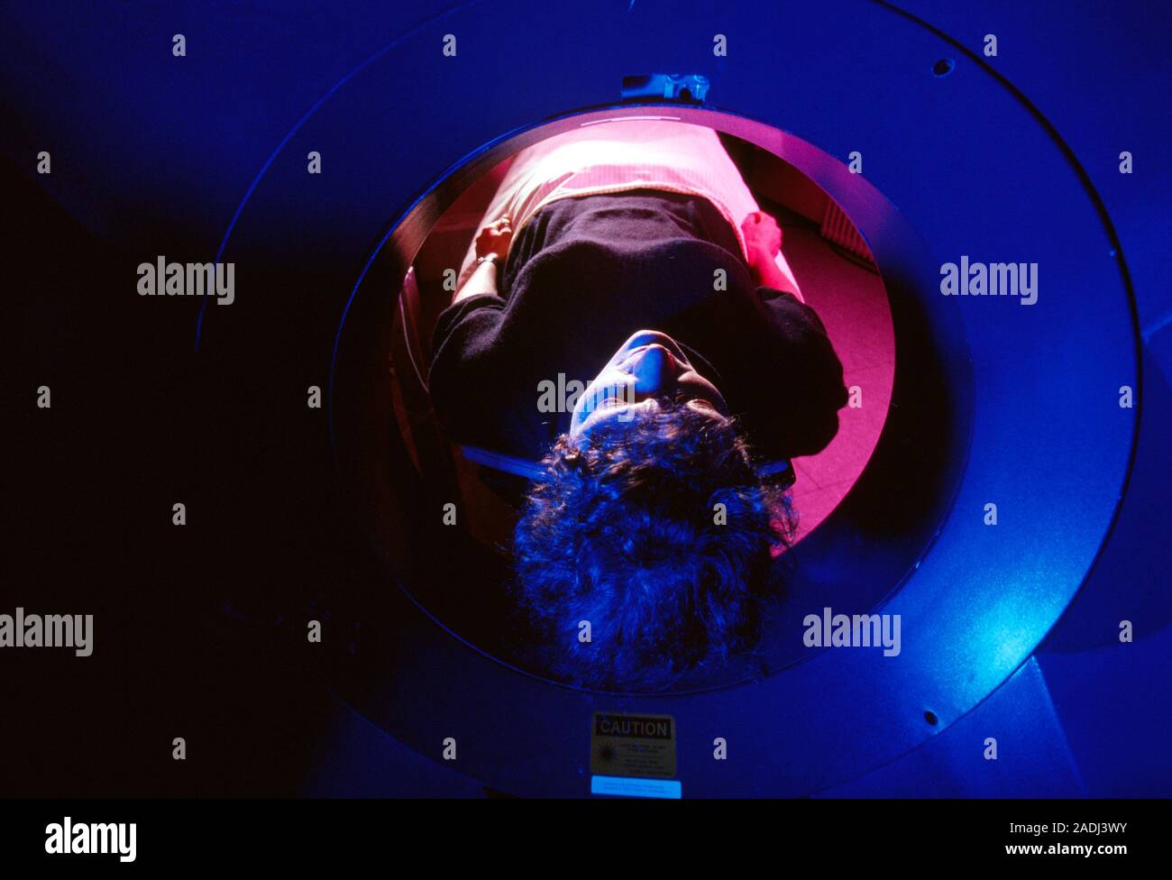 PET scanning. Head on view of a female patient undergoing a Positron ...