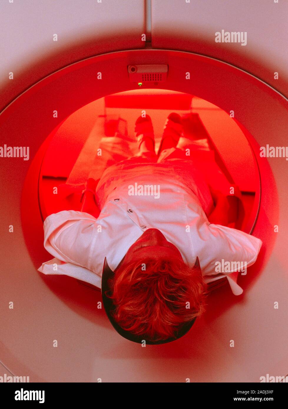 CT scanning. Female patient under- going an upper-body CT (Computed ...