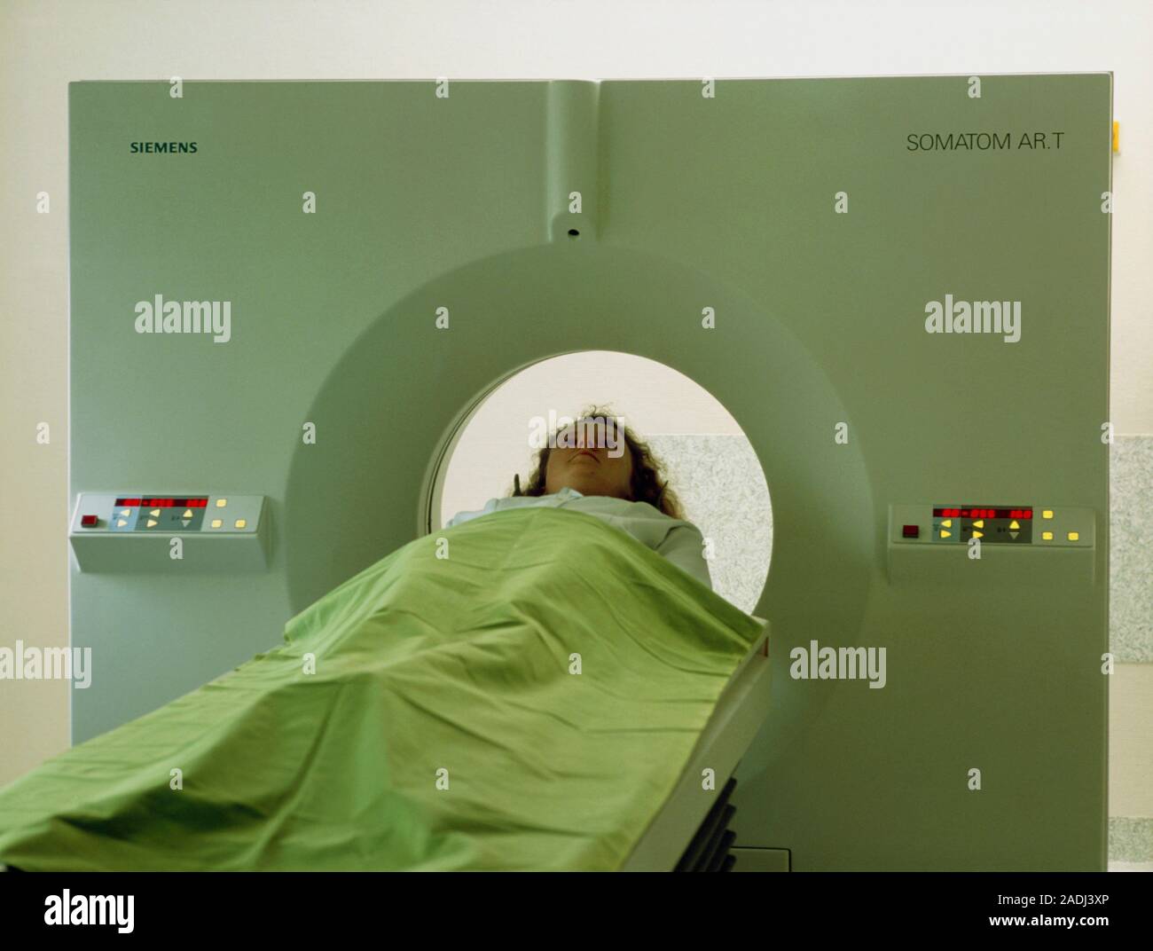 CT scanning. Patient passes into a computed tomography (CT) scanner ...