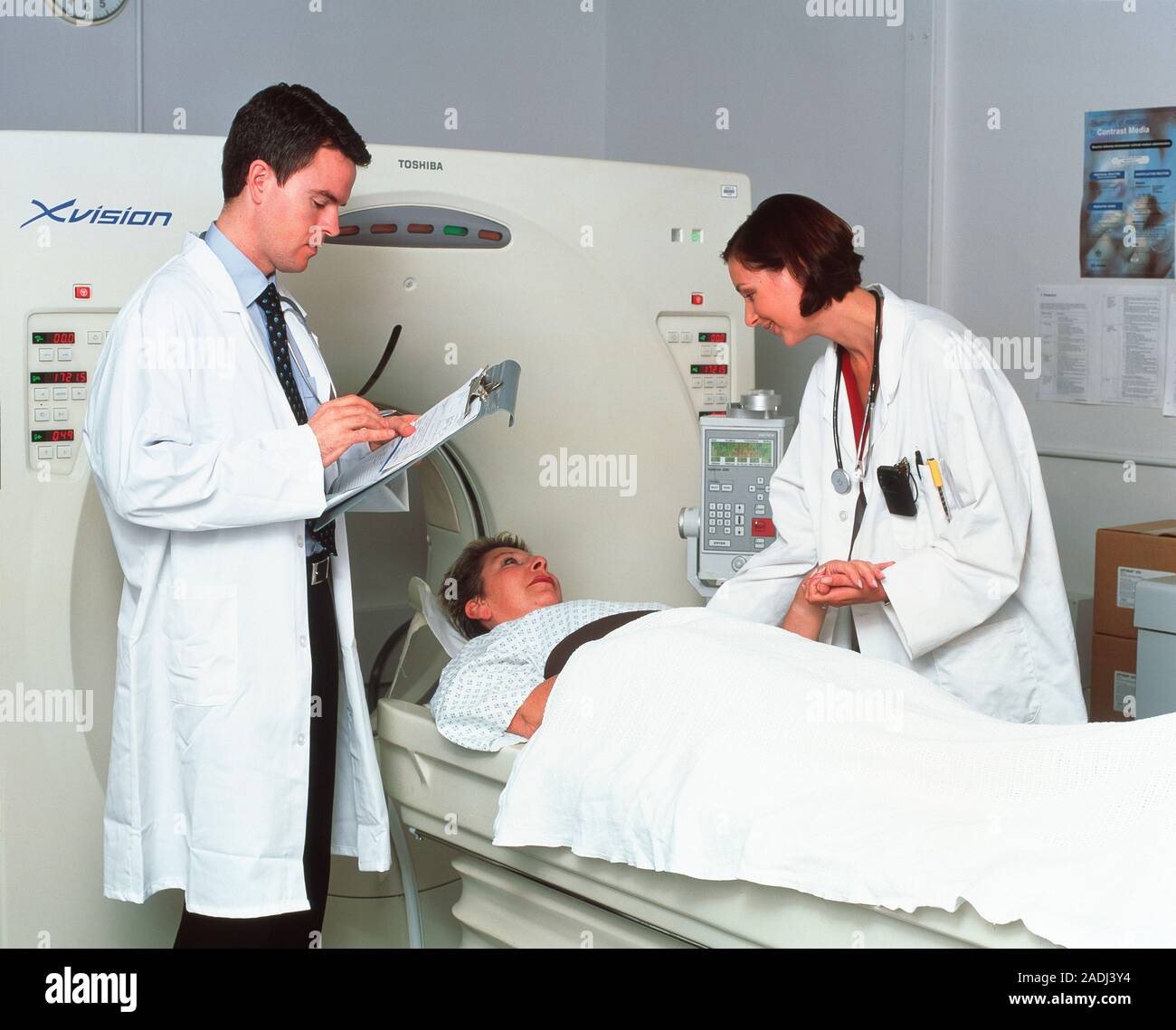 CT scan. Doctor reassures a patient about to be scanned by a CT ...