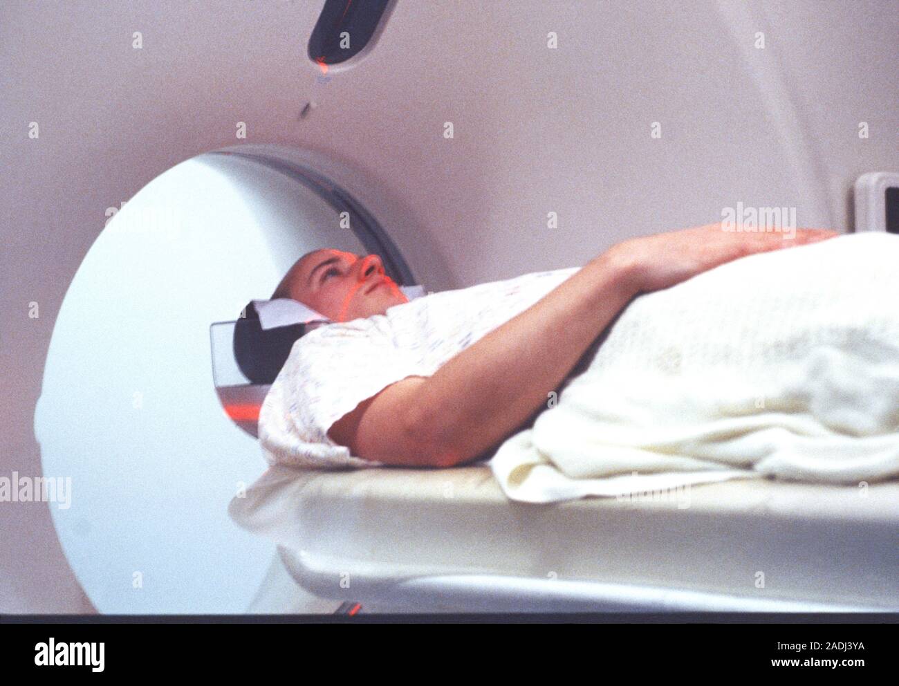 CT scanning. Male patient having his head scanned in a CT (computed ...