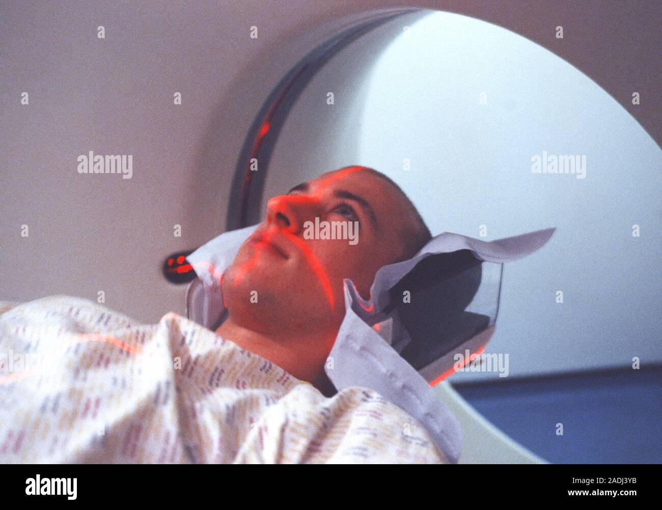 CT scanning. Male patient having his head scanned in a CT (computed ...