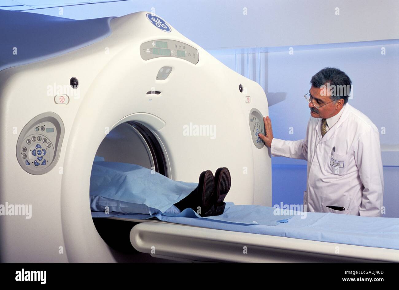 PET scanner. Patient in a positron emission tomography (PET) scanner ...