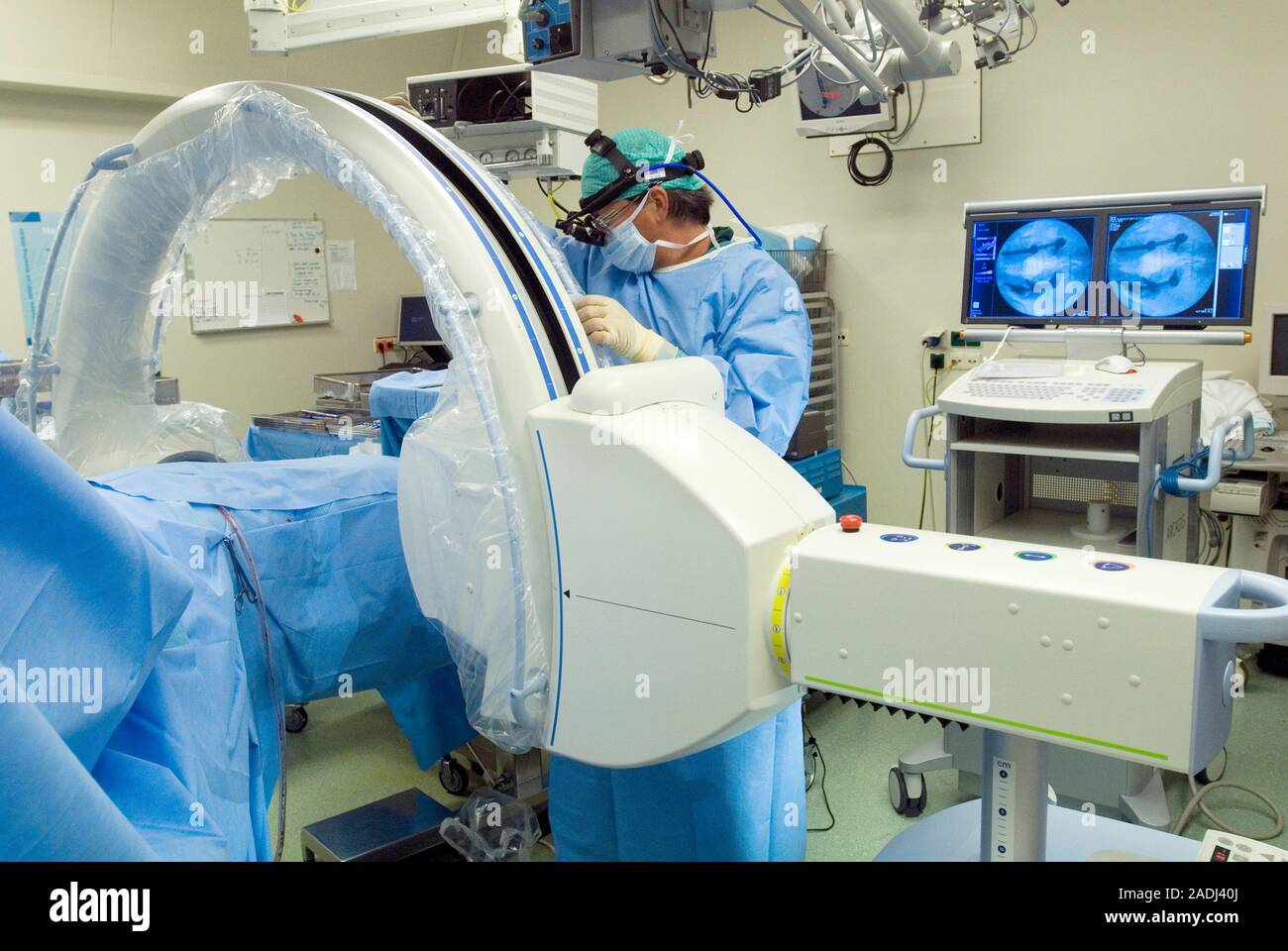 3D CT scanning during spinal surgery. Surgeon scanning a patient's ...