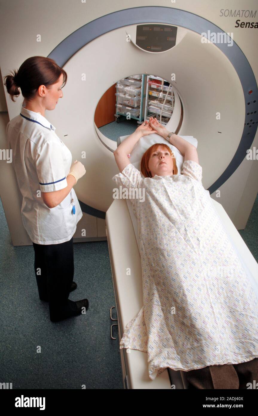 CT scanning. Patient being prepared for a CT scan. Computed tomography ...