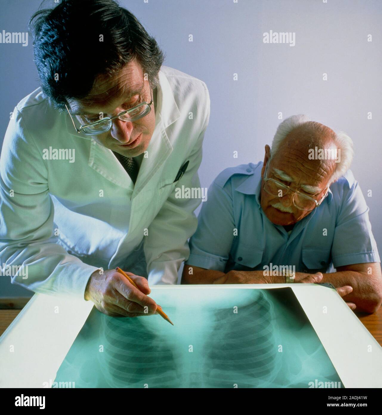 Doctor explaining features of a patient's chest x- ray. MODEL RELEASE ...