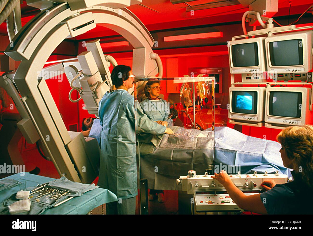 Cardiac catheterisation. Surgeons performing a cardiac catheterisation ...