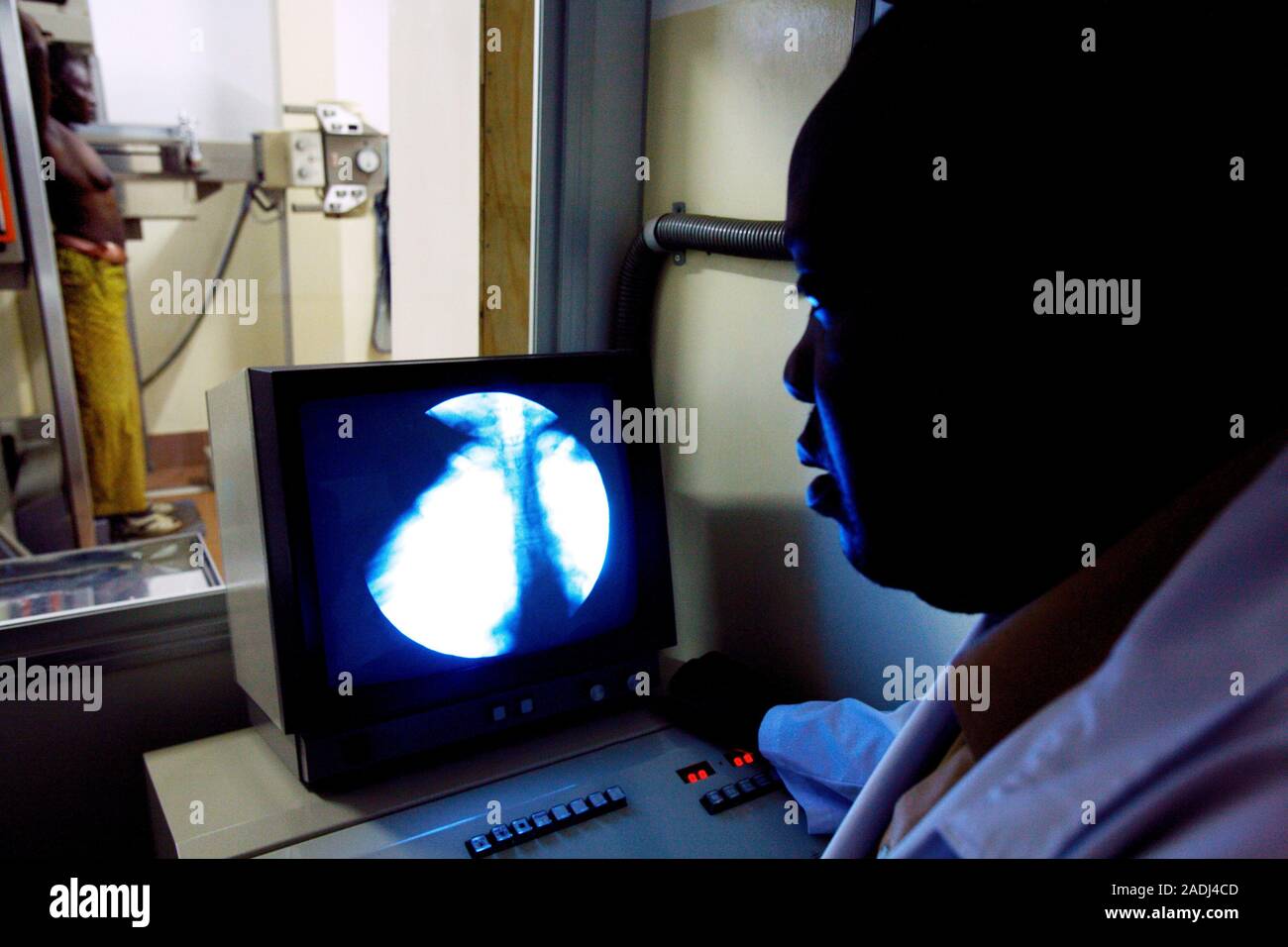 MODEL RELEASED. Taking X-rays. Radiographer (right) looking at a ...