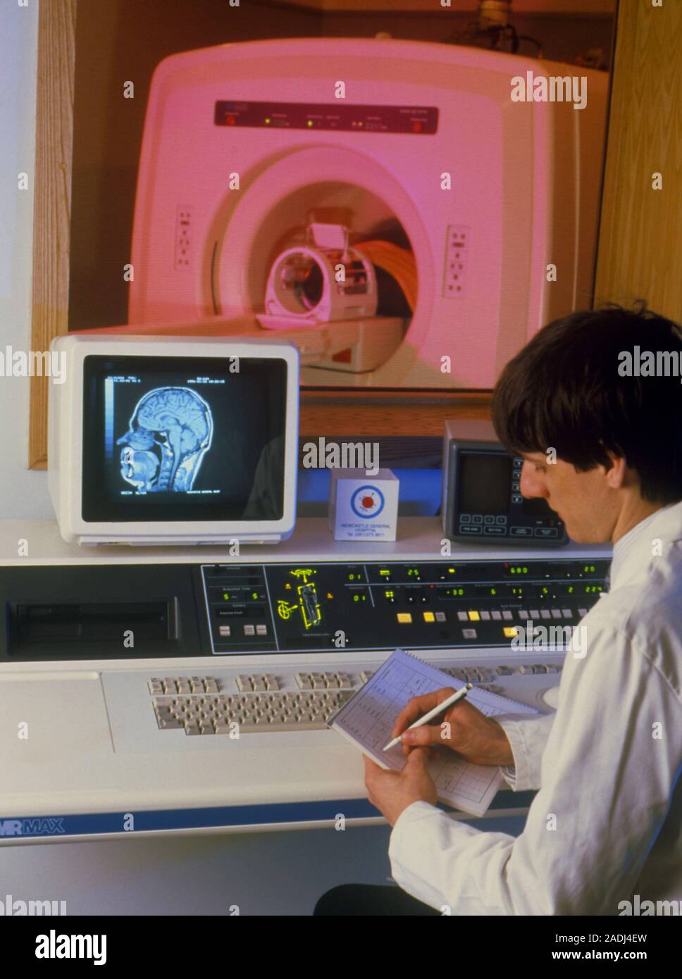 Man undergoing a magnetic resonance imaging (MRI) brain scan, showing ...