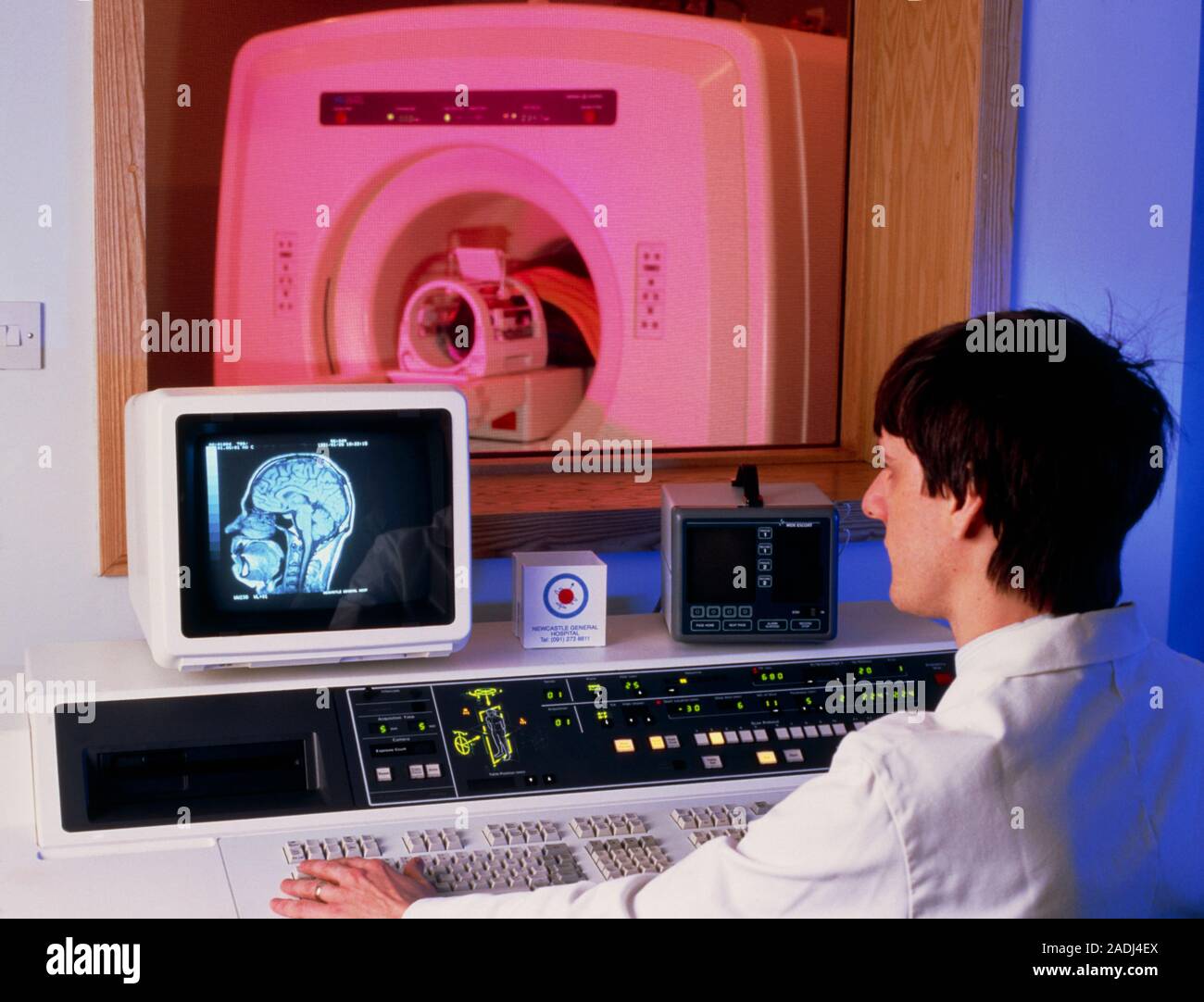 Man undergoing a magnetic resonance imaging (MRI) brain scan, showing ...