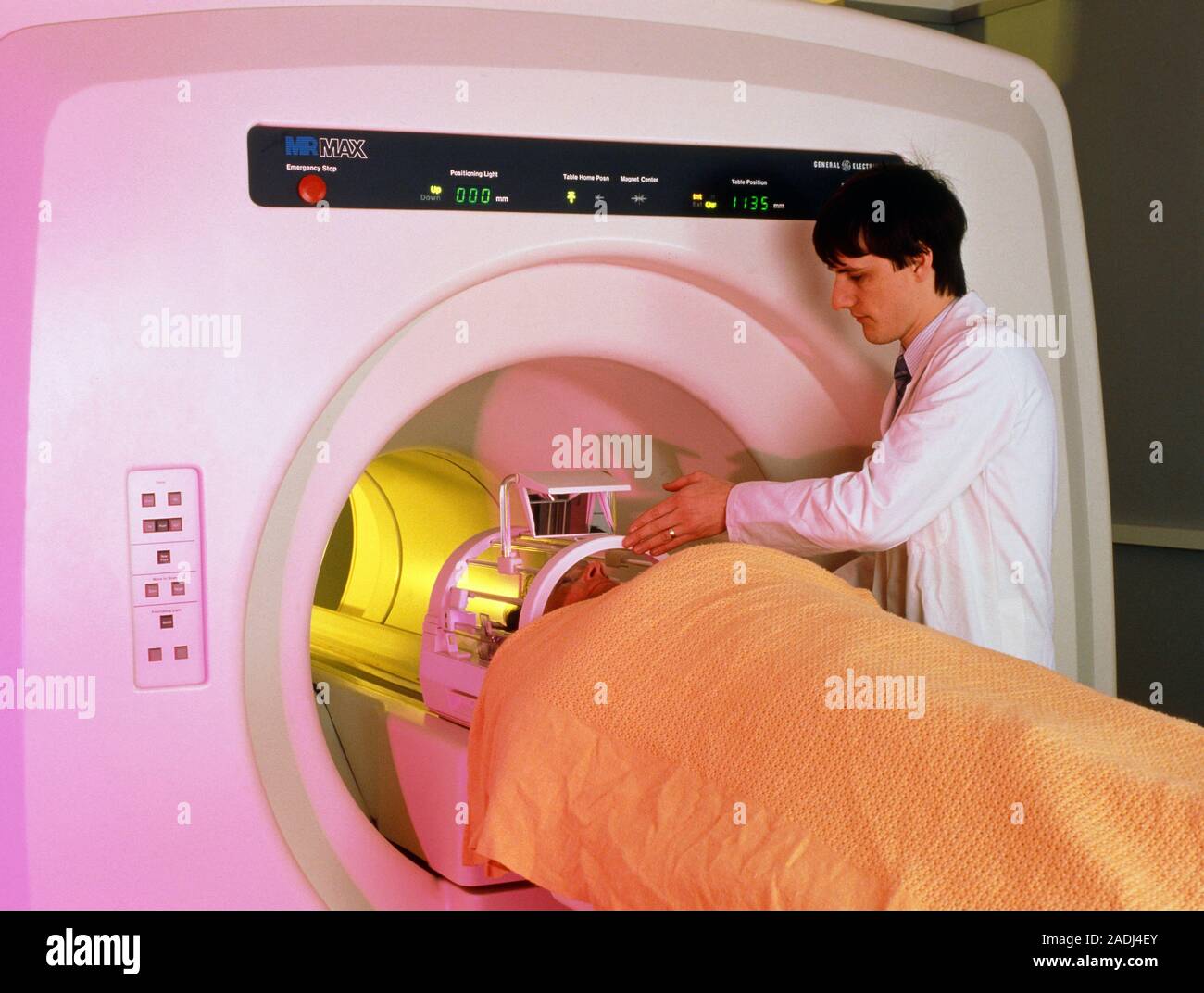 Radiographer preparing a patient for a magnetic resonance imaging (MRI ...