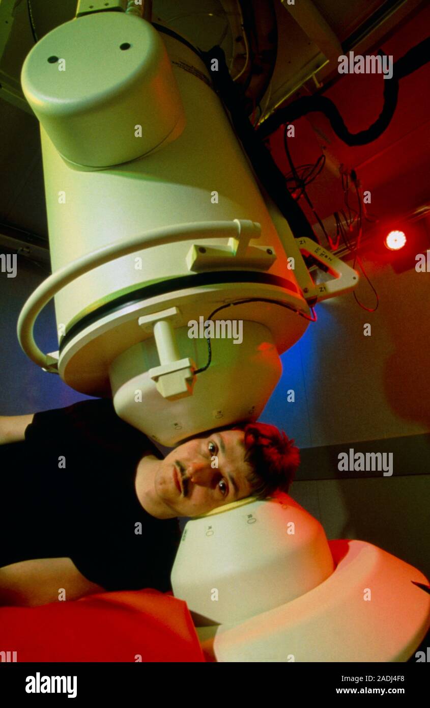 Magnetoencephalography (MEG). Man undergoing a brain scan with a ...