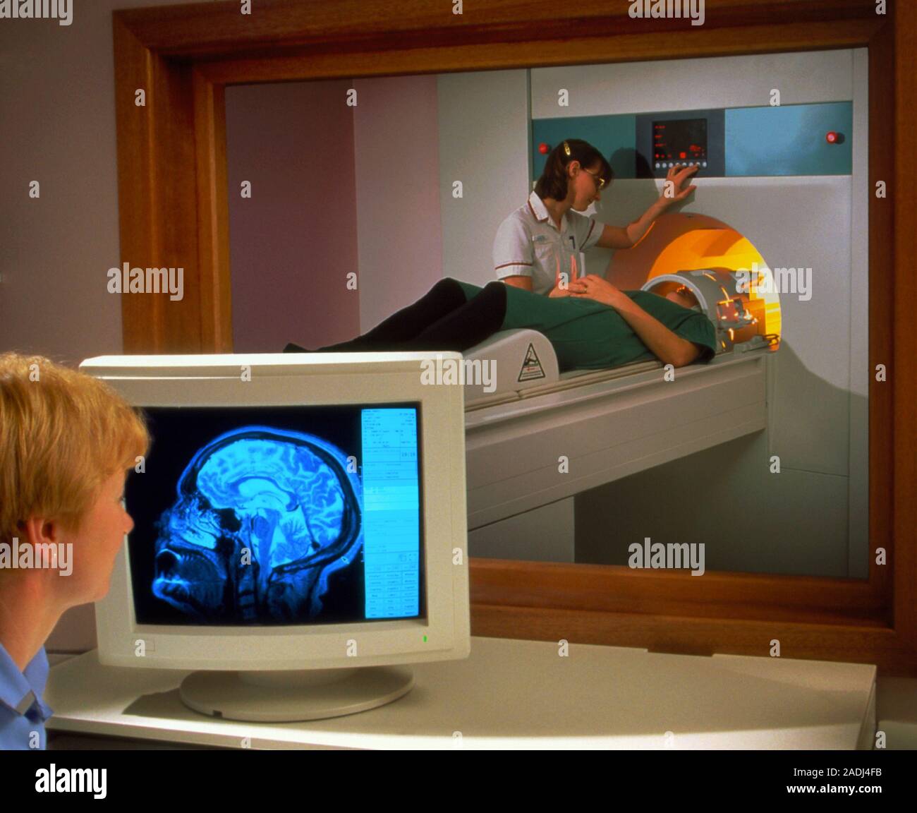 MRI brain scanning. Woman patient lies with her head in the circular ...