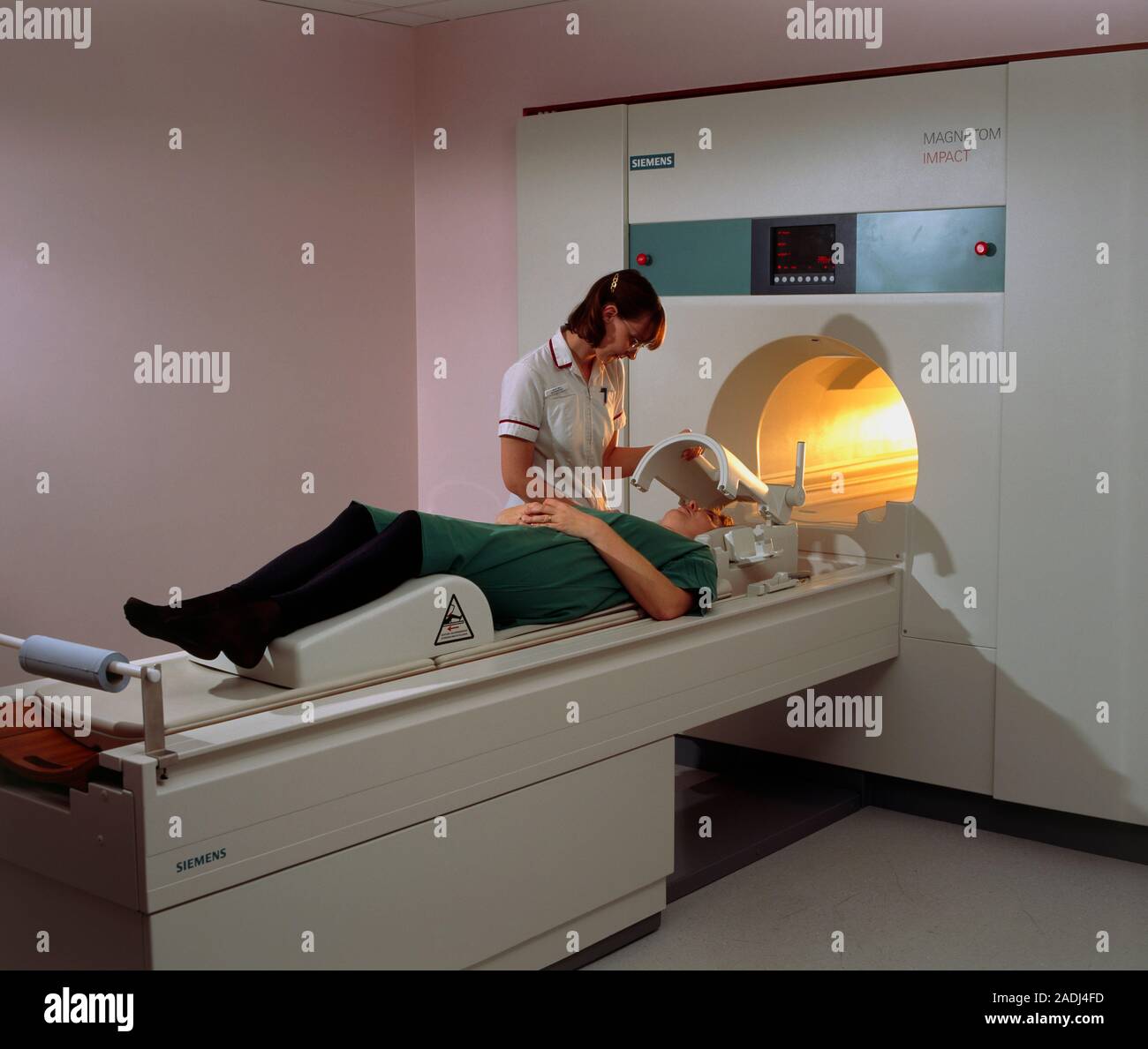 MRI brain scanning. A patient is prepared for a MRI (Magnetic Resonance ...