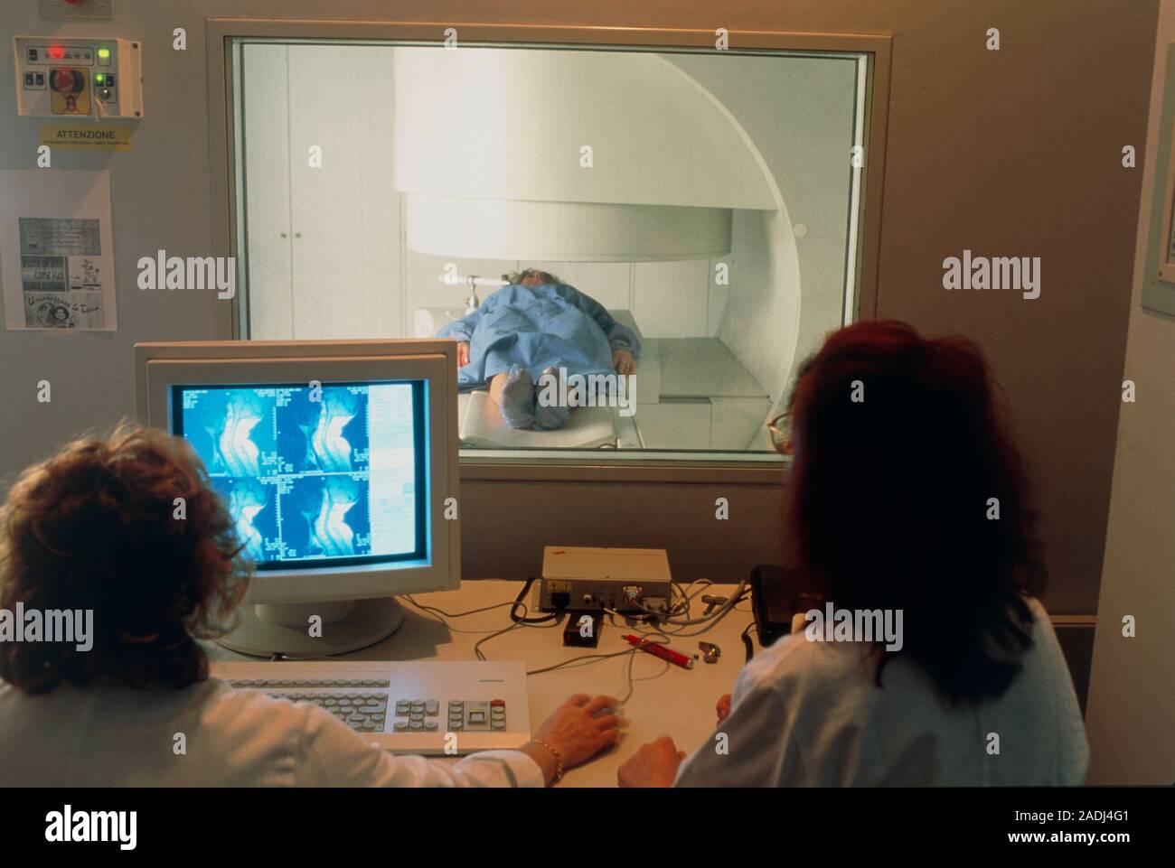MRI scanning. Woman patient lies underneath the detector of an MRI ...