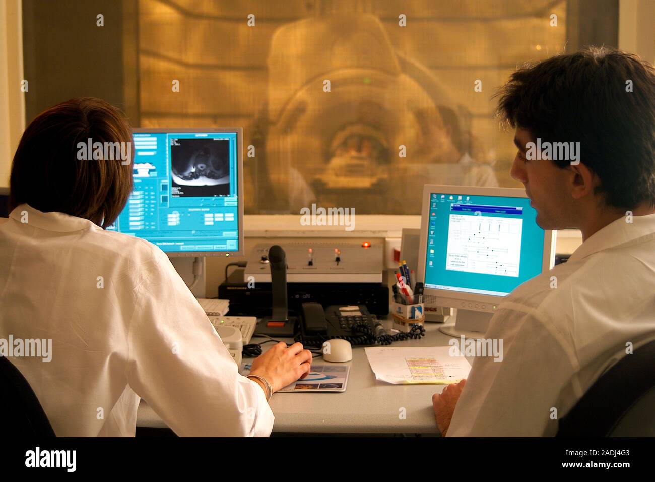 MRI scanning. Radiologists looking at a magnetic resonance imaging (MRI ...
