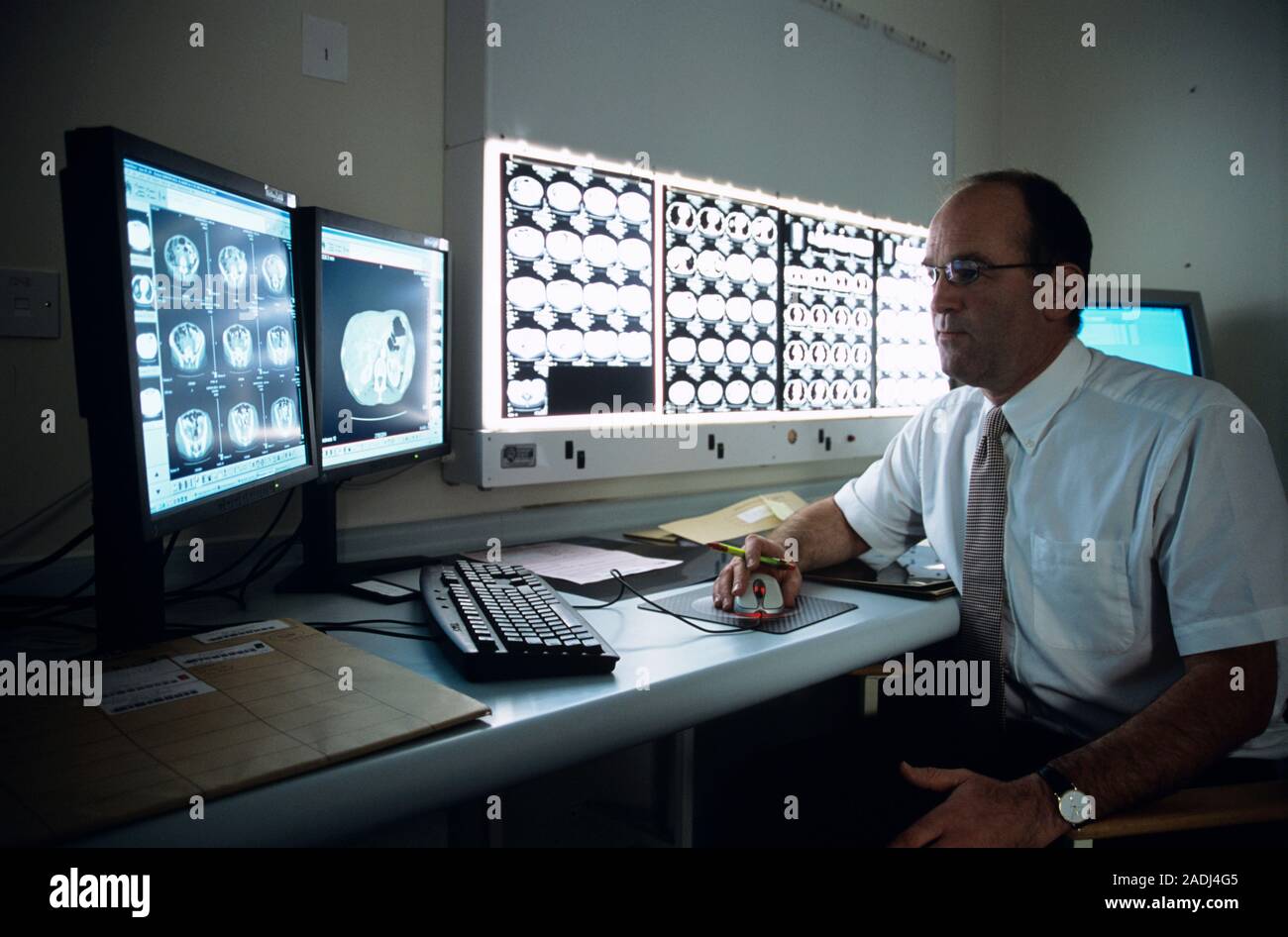 MODEL RELEASED. MRI scans. Radiographer examining a patient's magnetic ...