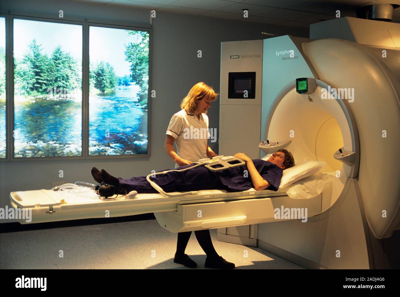 MODEL RELEASED. MRI scanner. Patient preparing for a magnetic resonance ...