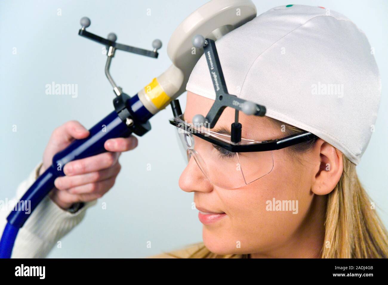 Brain mapping. Woman undergoing image-guided transcranial magnetic ...