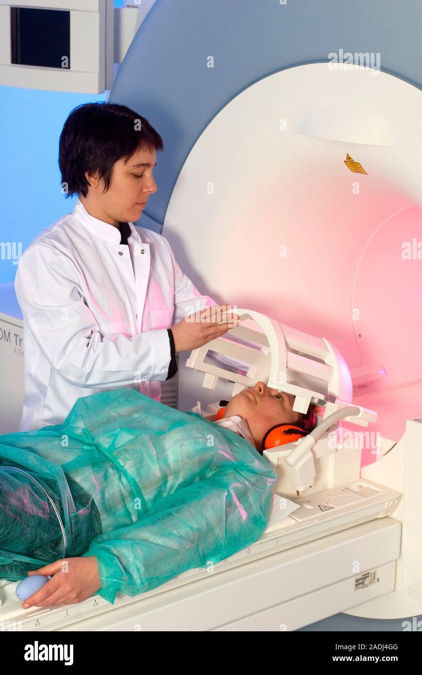 Neurospin MRI research. Researcher preparing a test subject for ...