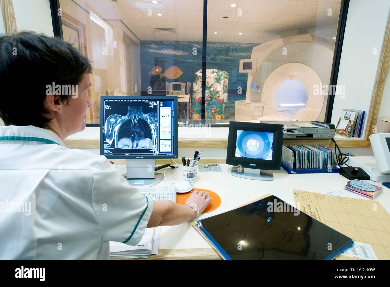 MRI scanning. Staff nurse monitoring a magnetic resonance imaging (MRI ...