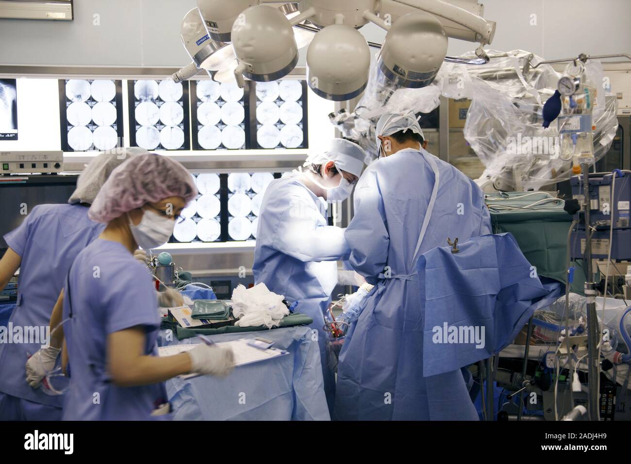 MRI surgery. Surgeons carrying out surgery in the vicinity of a ...