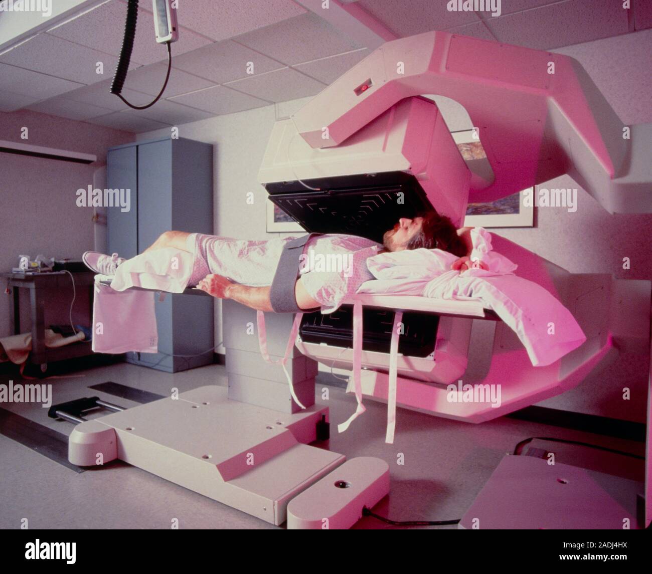 Gamma camera scan. Male patient undergoing a gamma camera scan ...