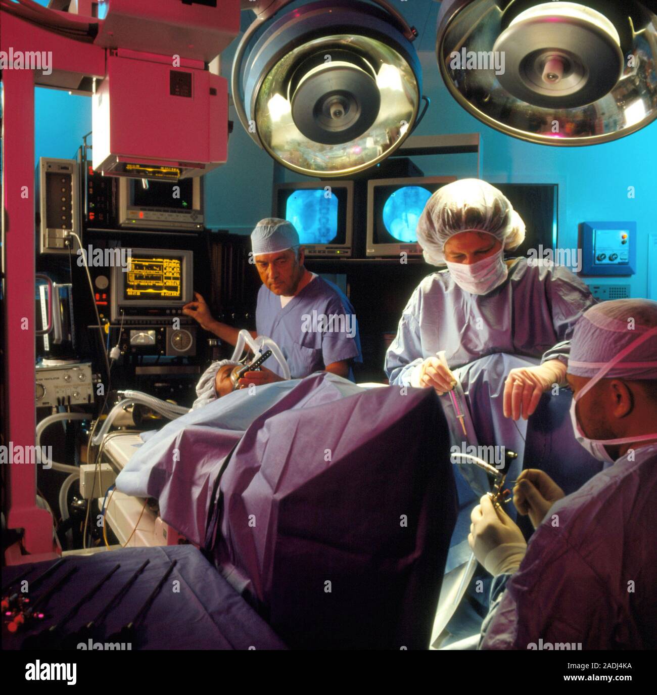 Colonoscopy procedure. Surgeons using a colonoscope, a type of flexible ...