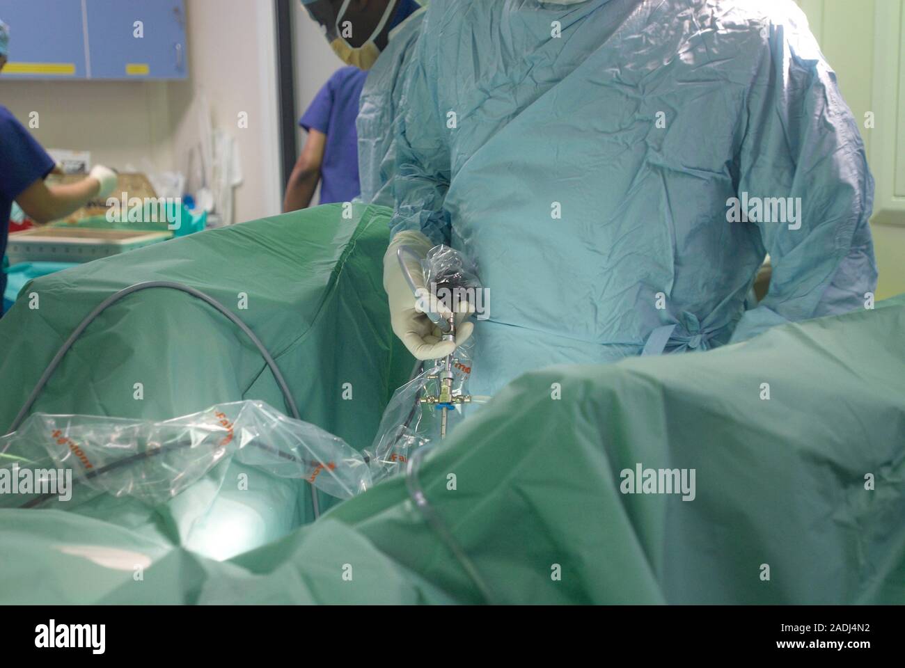 MODEL RELEASED. Endoscopy. Surgeon holding an endoscope probe during urogenital endoscopy ...